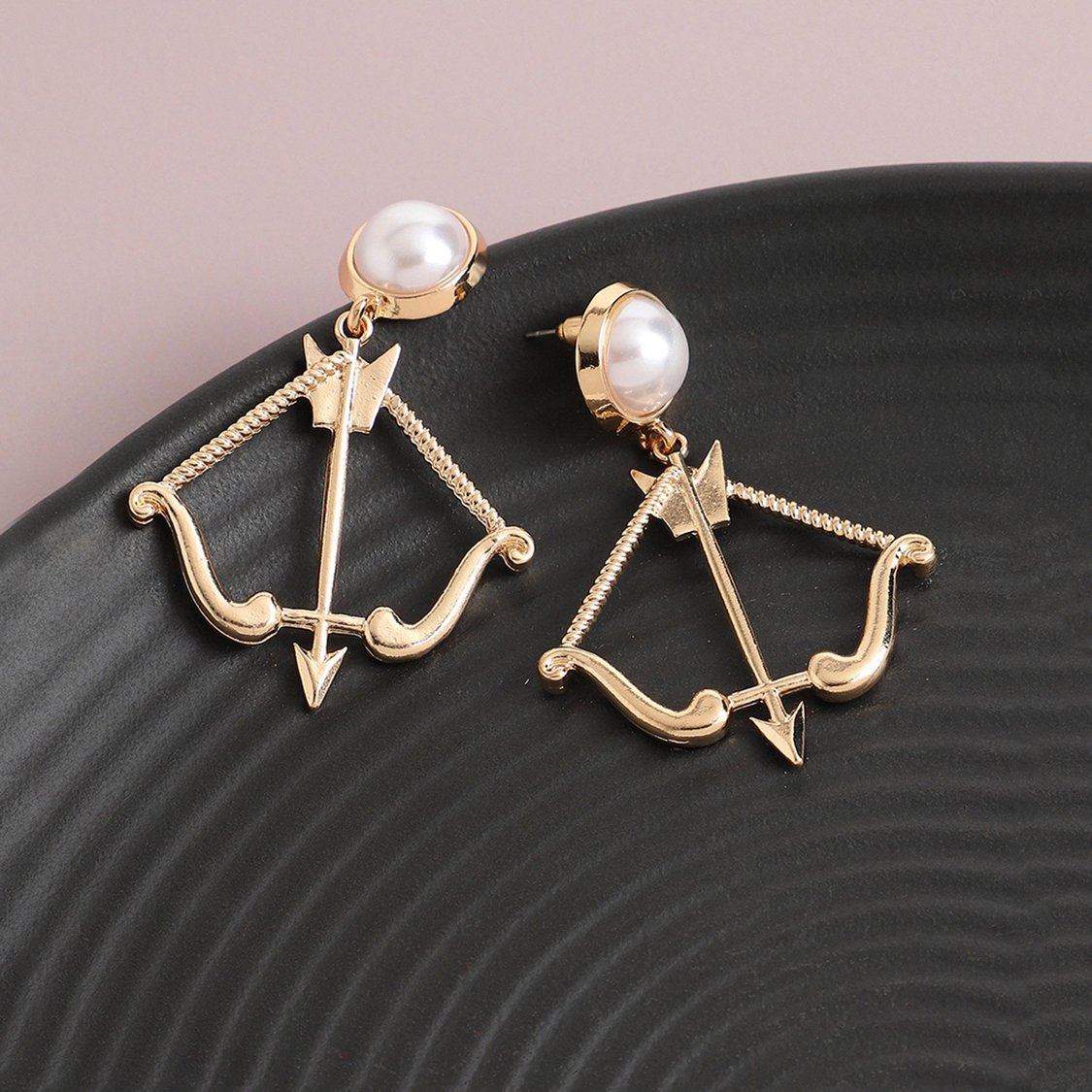 Buy SOHI Pearl Embellished Bow & Arrow Drop Earrings from Sohi at just ...